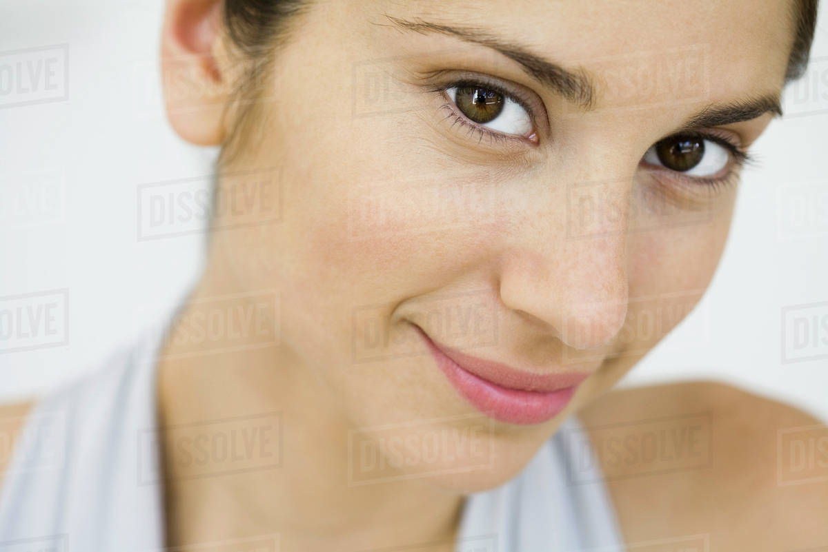Woman smiling at camera, portrait - Stock Photo - Dissolve