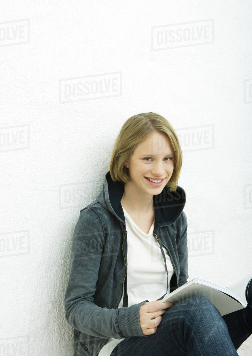 Teenage girl reading, portrait - Stock Photo - Dissolve