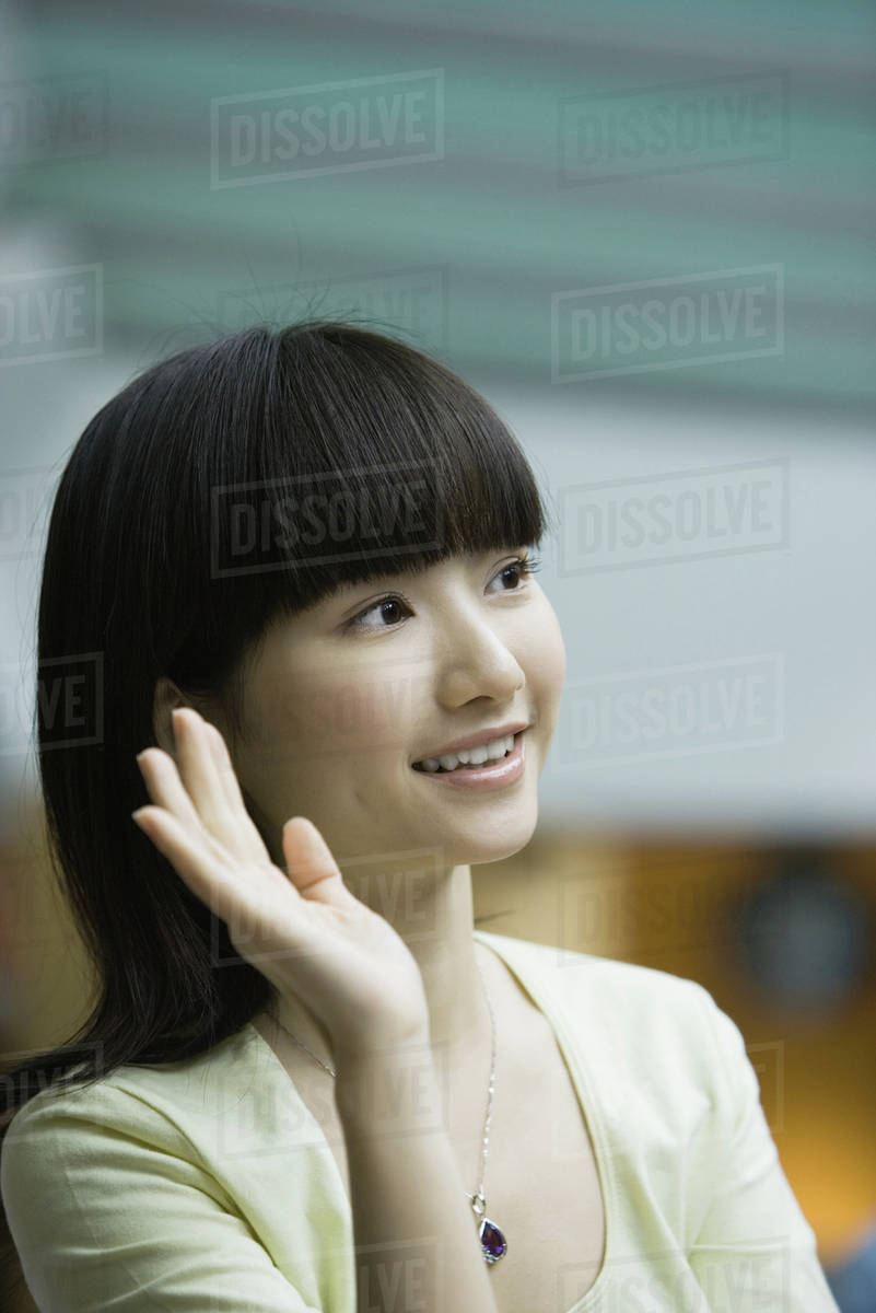 Young woman waving - Royalty-free Stock Photo | Dissolve