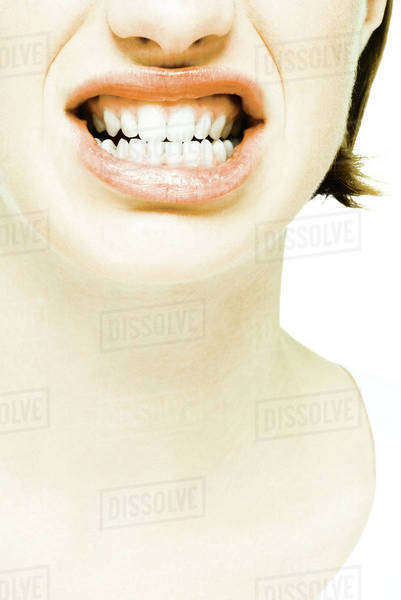 Teenage girl showing teeth, extreme close-up - Stock Photo - Dissolve