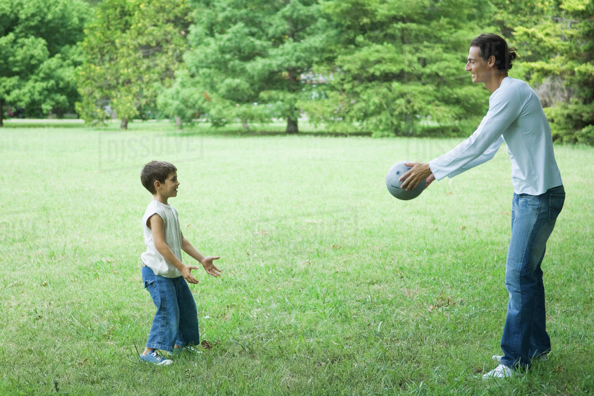Boy and father playing ball - Royalty-free Stock Photo | Dissolve