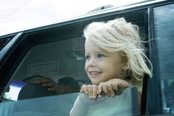 Child sticking head out of car window - Royalty-free Stock Photo | Dissolve