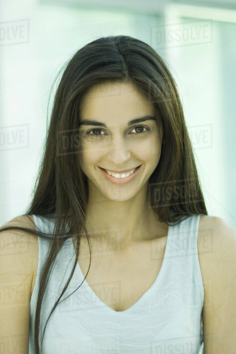 Young woman, looking at camera, head and shoulders, front view ...