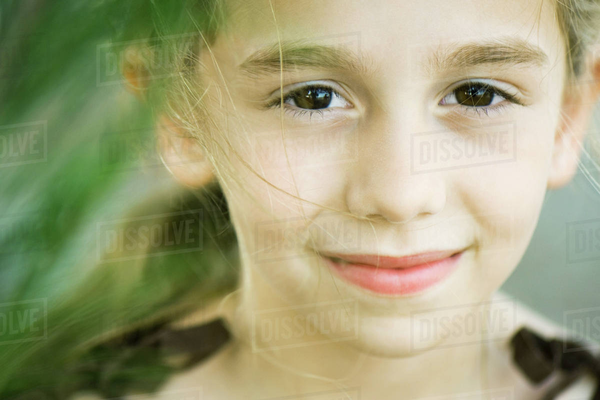 Girl smiling at camera, portrait - Royalty-free Stock Photo | Dissolve