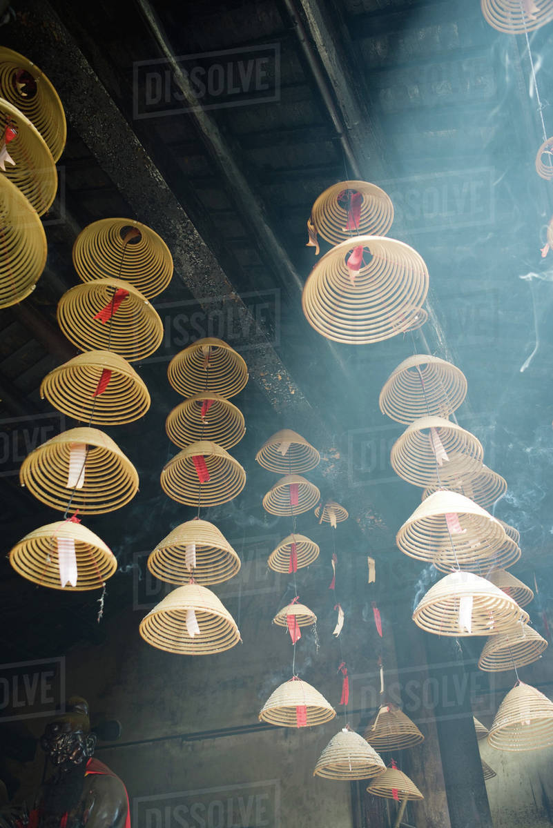 Incense hanging from ceiling in Chinese temple - Stock Photo - Dissolve