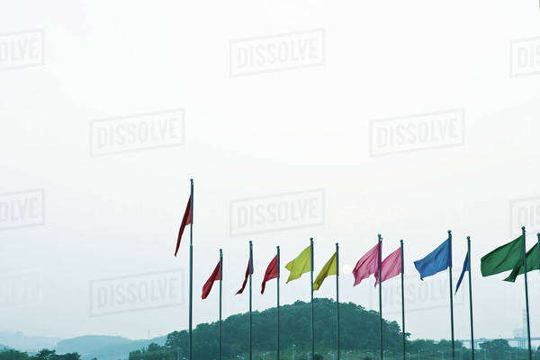 Flags, landscape in background - Stock Photo - Dissolve