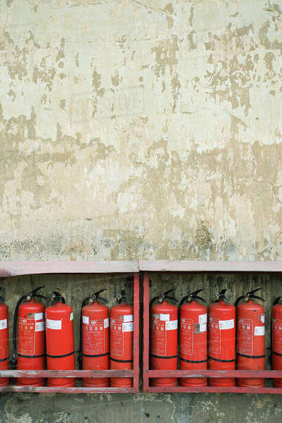 Row of fire extinguishers - Stock Photo - Dissolve