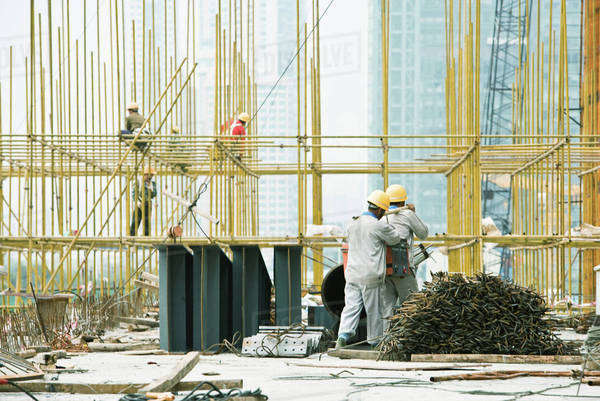 Construction workers working at construction site - Stock Photo - Dissolve