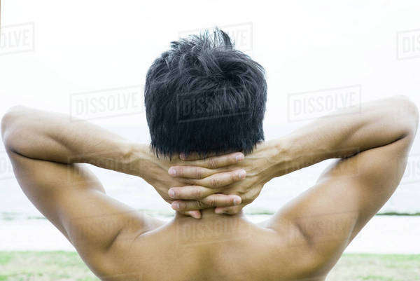 Man with hands clasped behind head, rear view - Royalty-free Stock ...