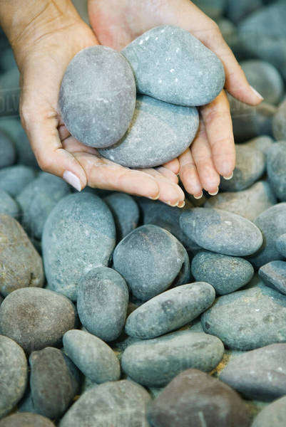 Hands holding pebbles, close-up - Royalty-free Stock Photo | Dissolve