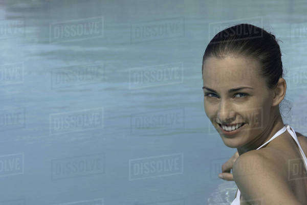 Woman, head and shoulders, water in background - Stock Photo - Dissolve