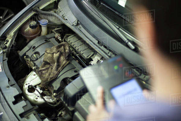 Mechanic working on car engine - Royalty-free Stock Photo | Dissolve