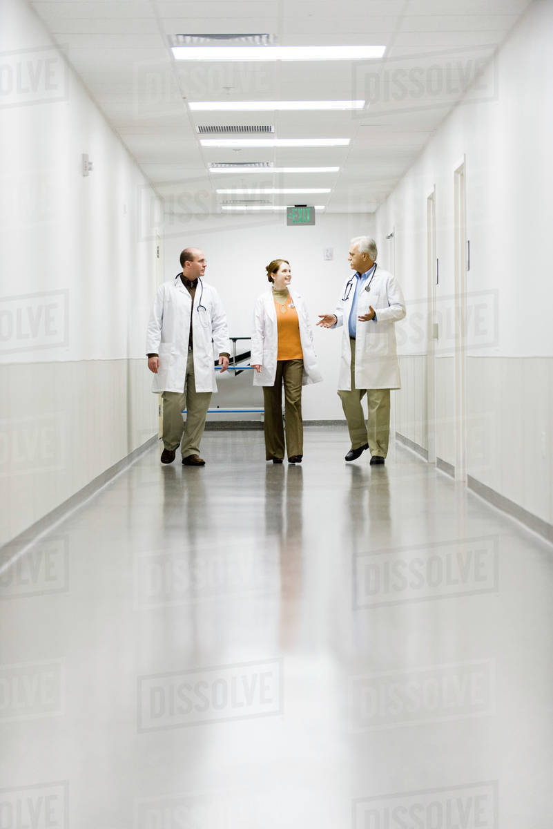 Doctors walking down hospital corridor - Royalty-free Stock Photo ...