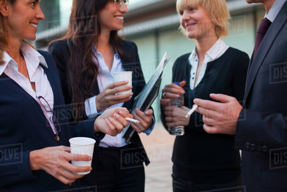 Colleagues taking smoking break outdoors - Royalty-free Stock Photo ...