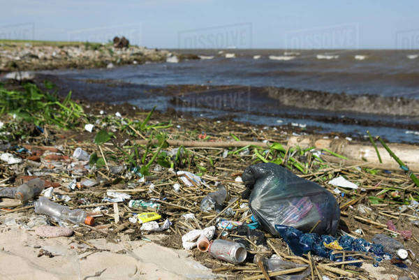 Trash washed up along shore - Royalty-free Stock Photo | Dissolve