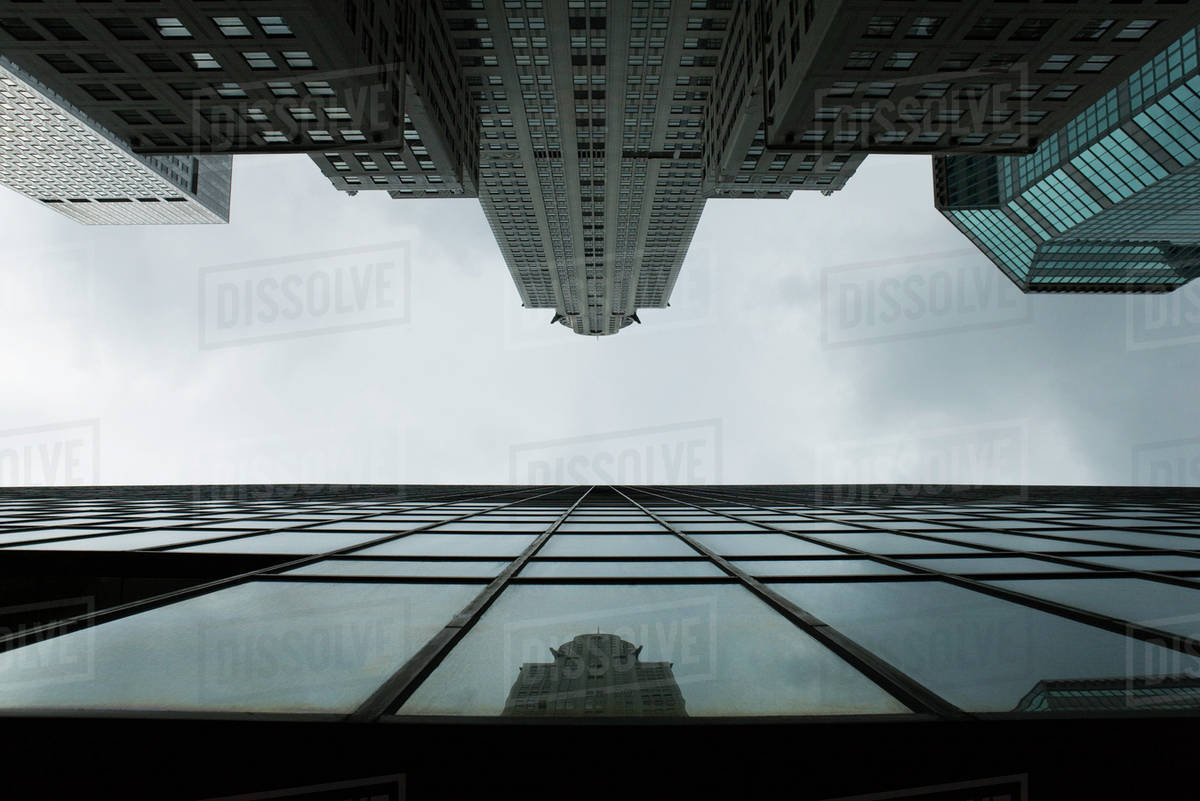 Reflection of skyscraper on glass facade of building on opposite side ...