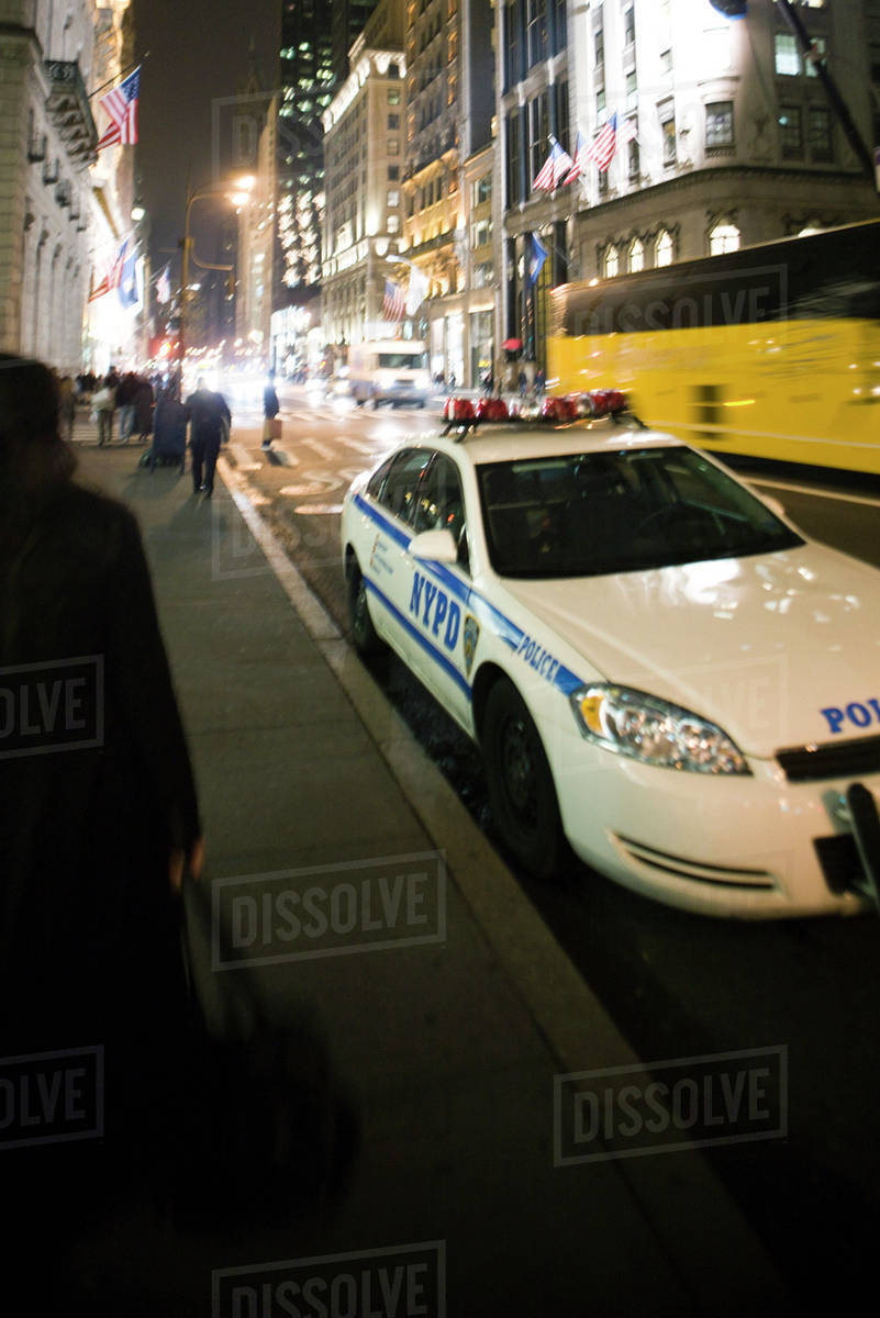 Police car parked on busy street - Stock Photo - Dissolve