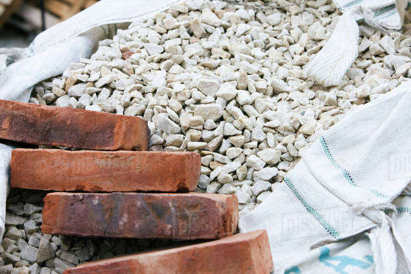Bricks set on top of sack of gravel - Royalty-free Stock Photo | Dissolve