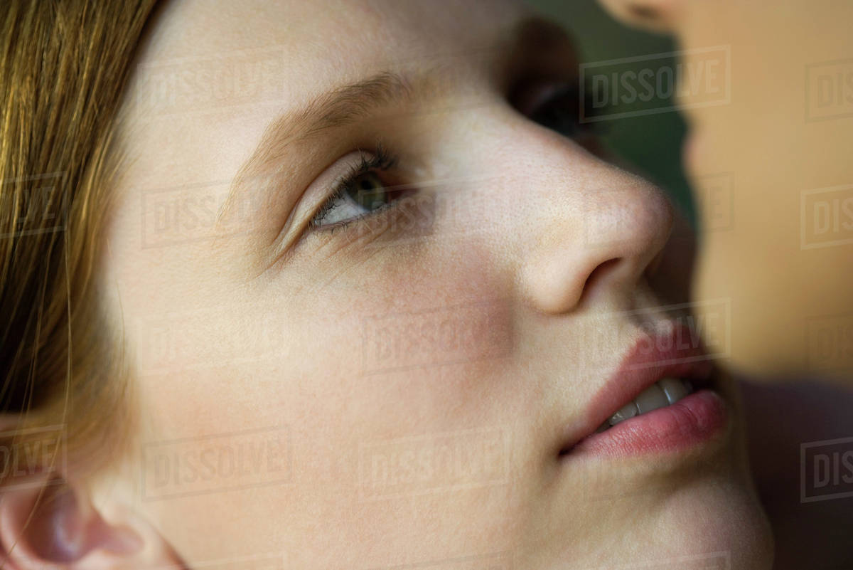 Young woman gazing at man's face, extreme close-up - Royalty-free Stock ...