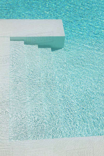 Steps leading down into swimming pool - Stock Photo - Dissolve