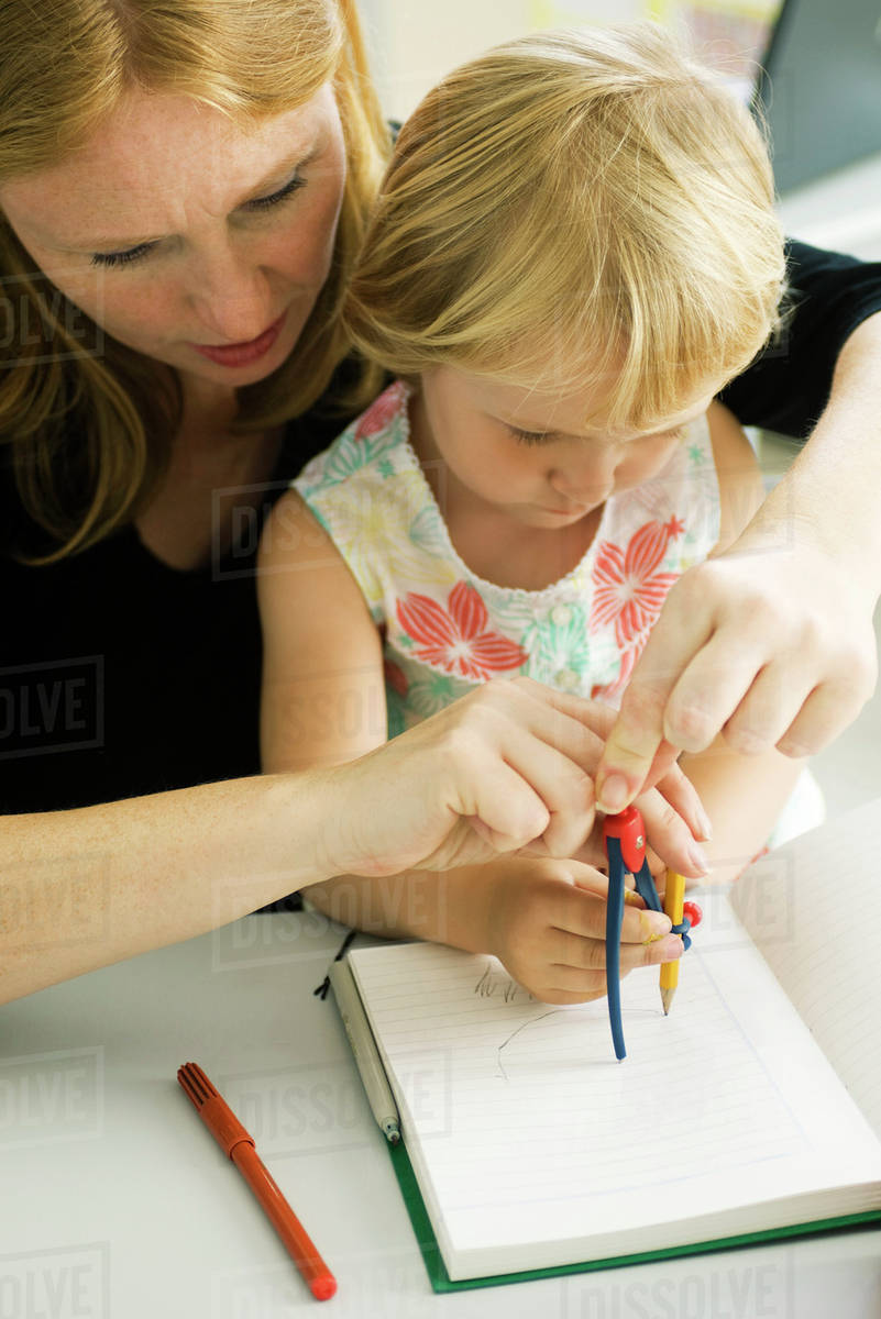 Woman helping little girl draw with compass - Royalty-free Stock Photo ...