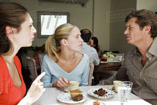 Friends having discussion at cafe - Stock Photo - Dissolve