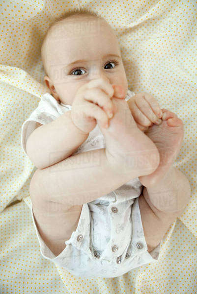Baby touching its toes - Stock Photo - Dissolve