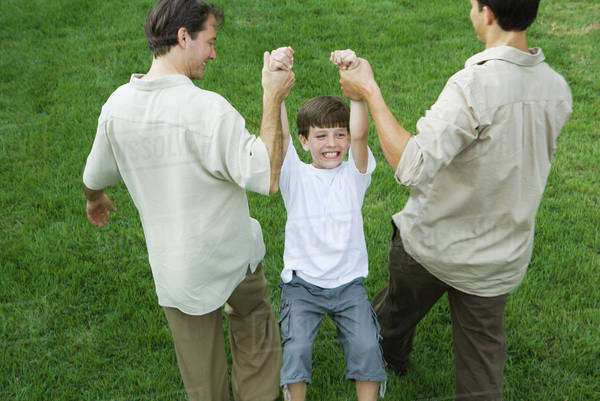 Two men carrying boy by his arms, high angle view - Royalty-free Stock ...