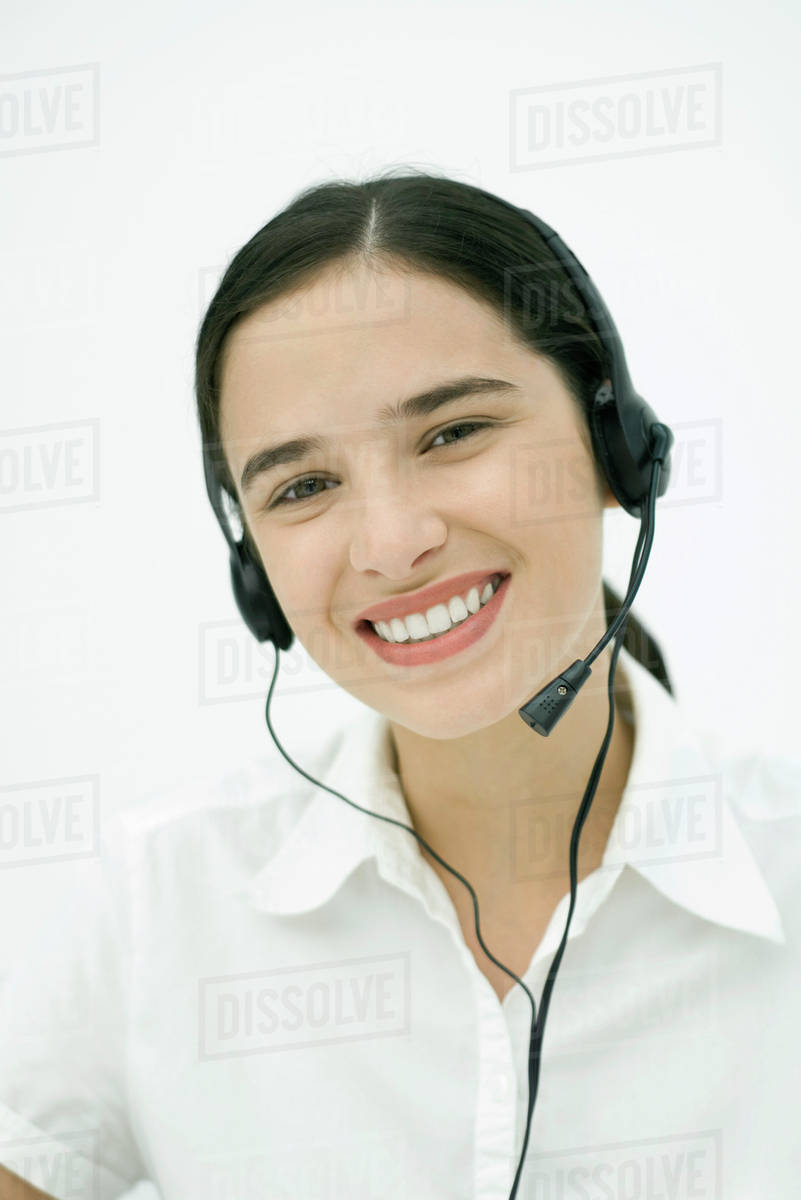 Woman wearing headset, smiling at camera, portrait - Royalty-free Stock ...