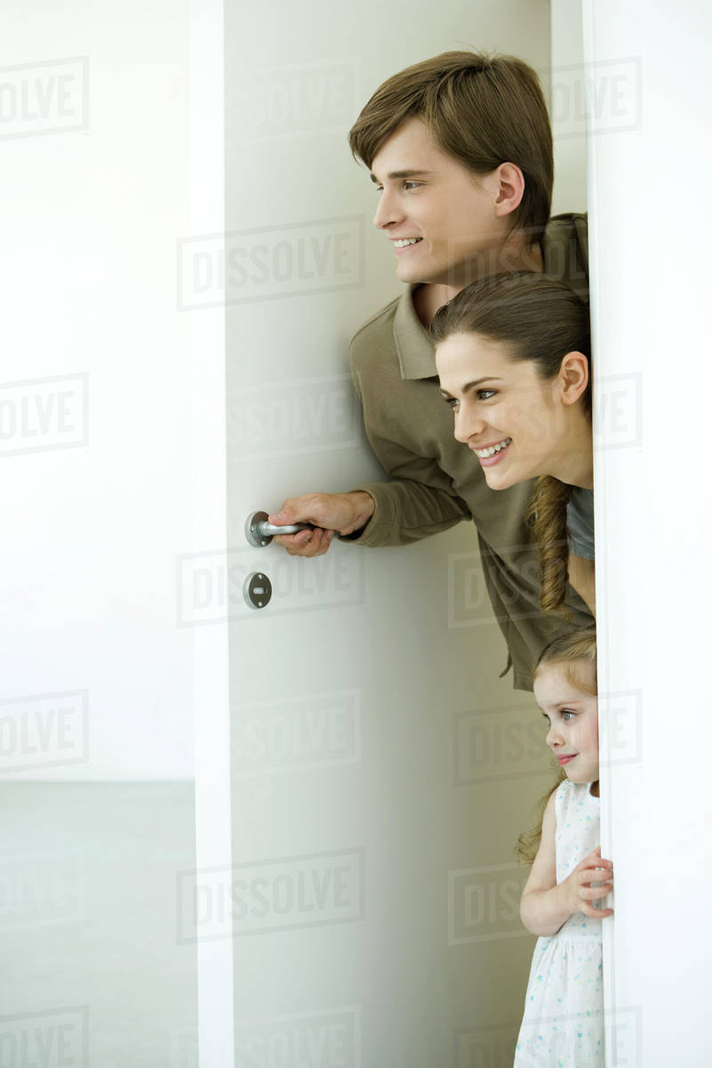 Family peeking in doorway - Royalty-free Stock Photo | Dissolve