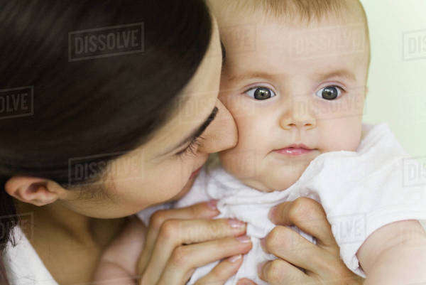 Woman nuzzling baby, close-up - Stock Photo - Dissolve