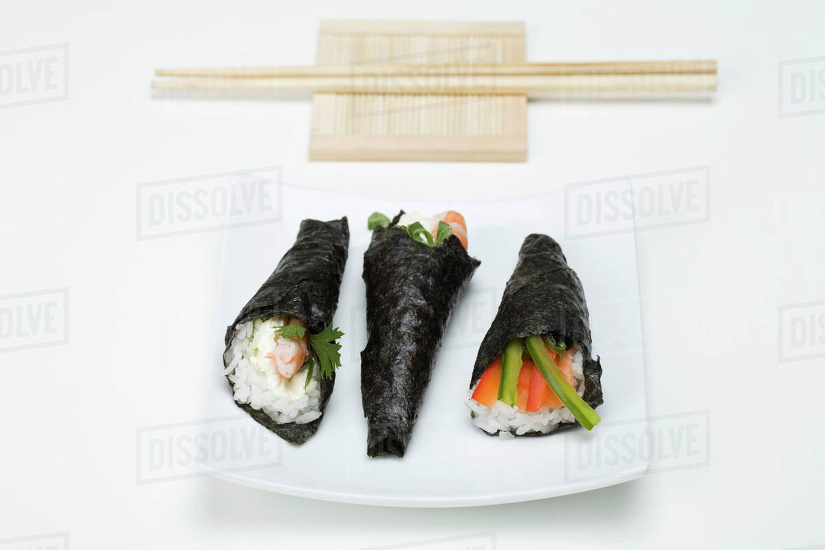 Temaki sushi on sushi plate with chopsticks - Stock Photo - Dissolve