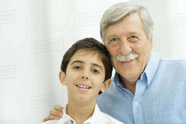 Grandfather and grandson smiling at camera, portrait - Royalty-free ...
