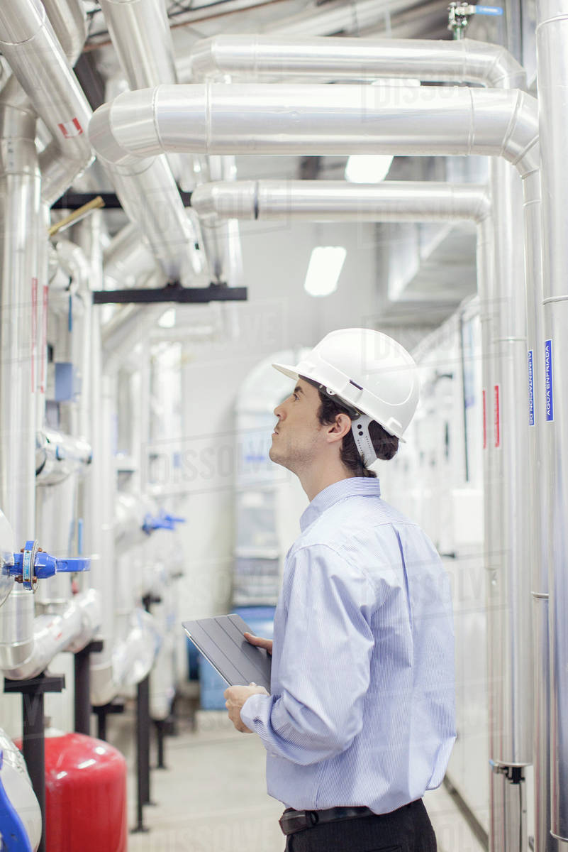 Engineer checking equipment in operation at industrial plant - Royalty ...