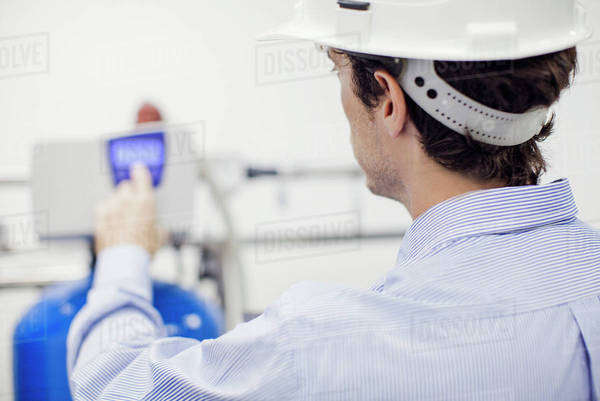 Technician operating industrial equipment - Royalty-free Stock Photo ...