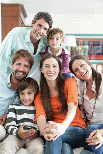 Family together in living room, portrait - Stock Photo - Dissolve