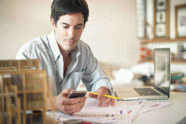 Office worker using cell phone - Royalty-free Stock Photo | Dissolve