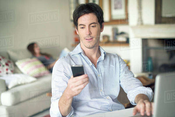 Man looking at cell phone - Royalty-free Stock Photo | Dissolve