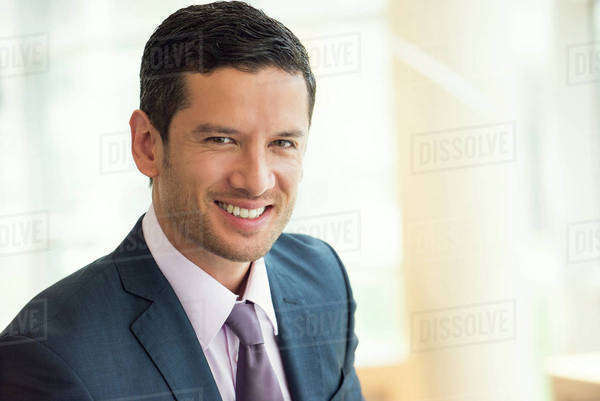 Businessman smiling, portrait - Stock Photo - Dissolve