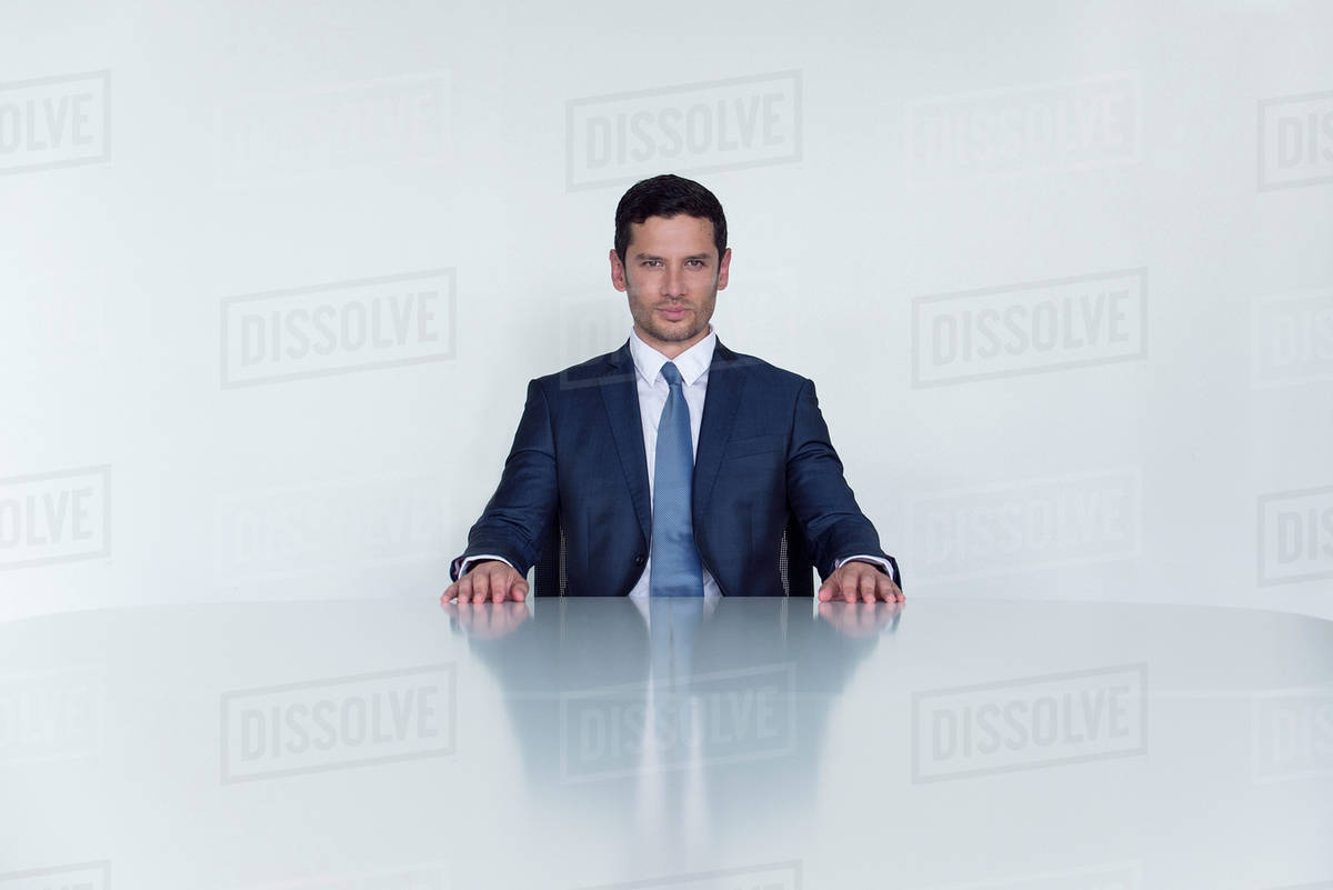 Businessman seated at table, portrait - Royalty-free Stock Photo | Dissolve