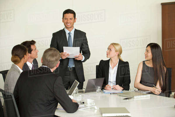 Executive giving presentation in meeting - Stock Photo - Dissolve