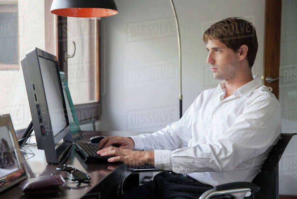 Man using desktop computer - Royalty-free Stock Photo | Dissolve