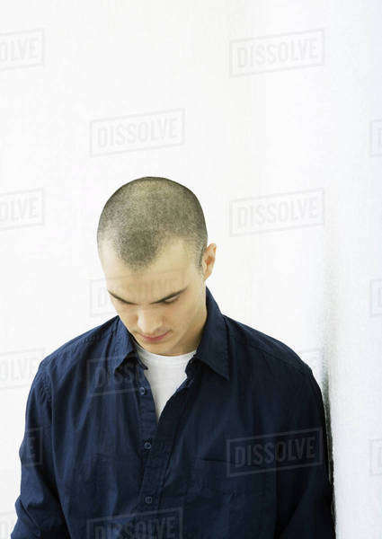 Young man with head down - Royalty-free Stock Photo | Dissolve