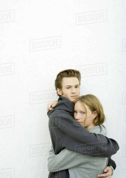 Young man and woman hugging, looking at camera - Royalty-free Stock ...