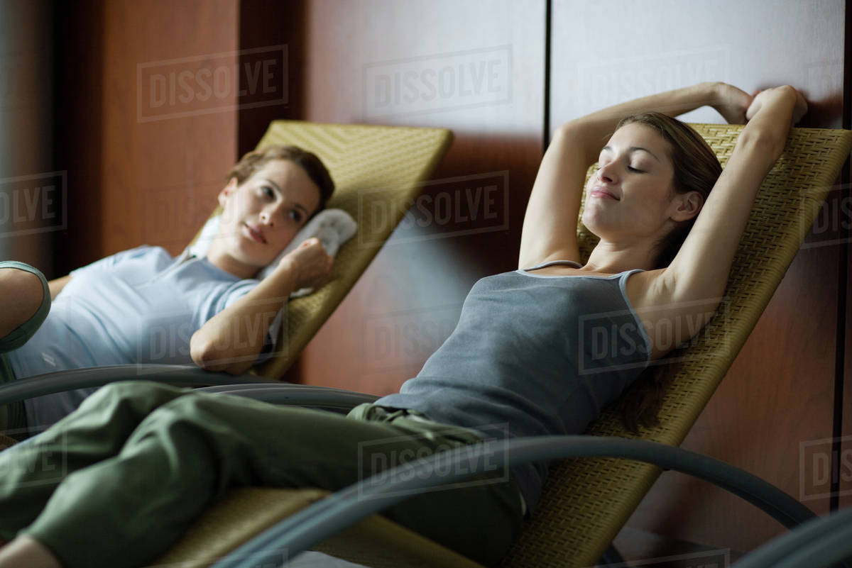 Two young women relaxing in lounge chairs - Royalty-free Stock Photo ...