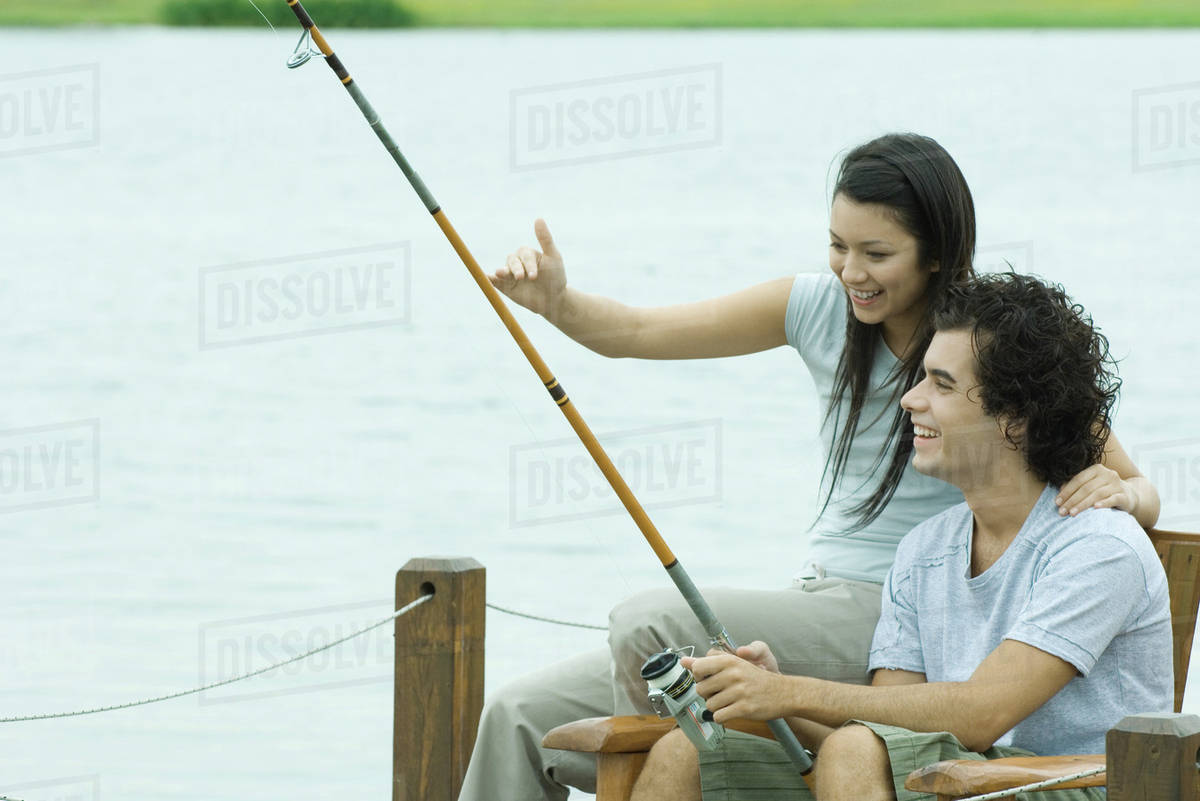 Couple fishing on pier - Royalty-free Stock Photo | Dissolve