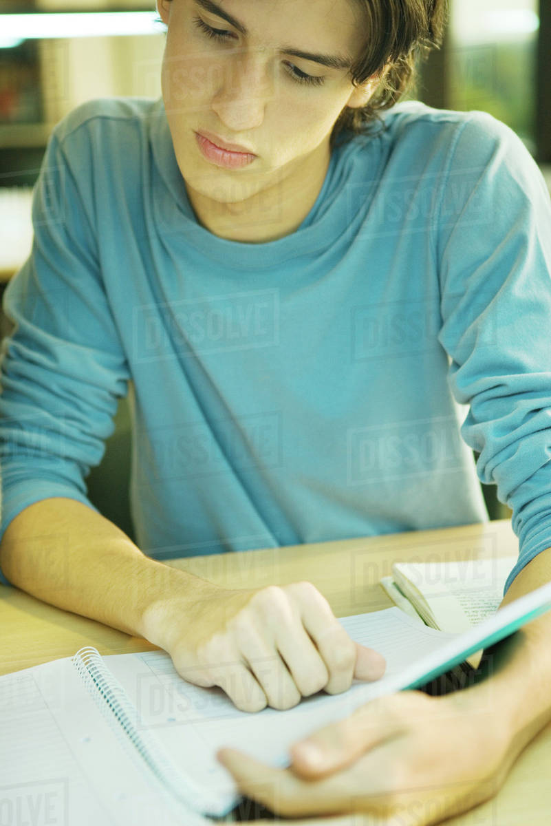 Male college student sitting in library, studying - Royalty-free Stock ...