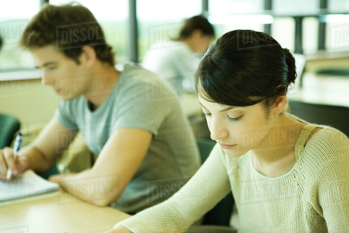 College students studying at tables in library - Royalty-free Stock ...