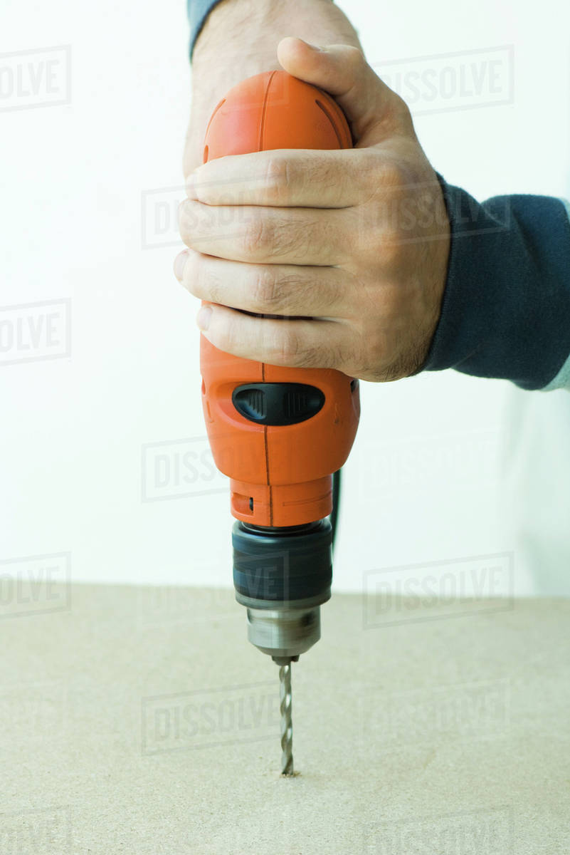 Man using drill, cropped view of hands - Royalty-free Stock Photo ...