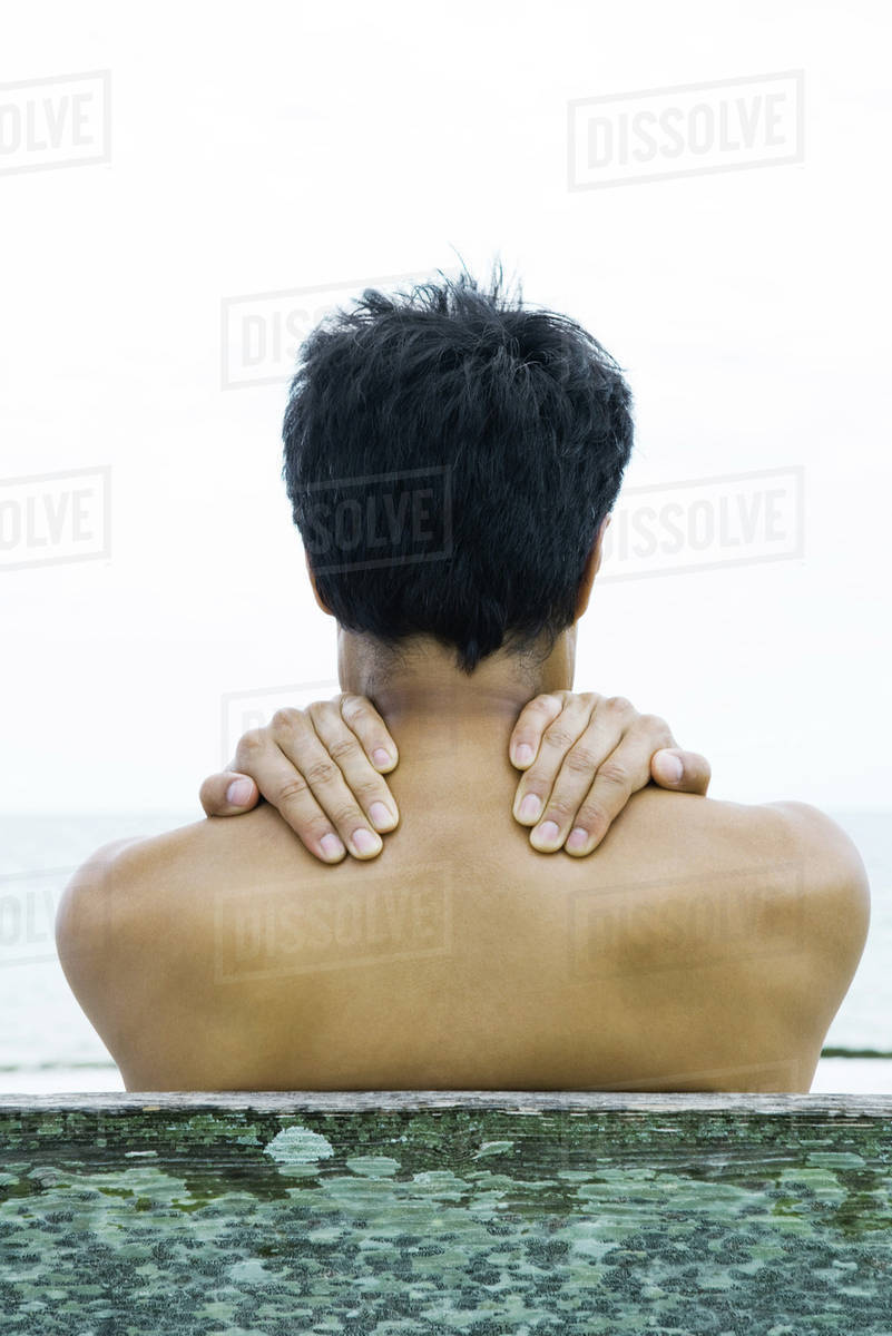 Man with hands on his shoulders, rear view - Royalty-free Stock Photo ...